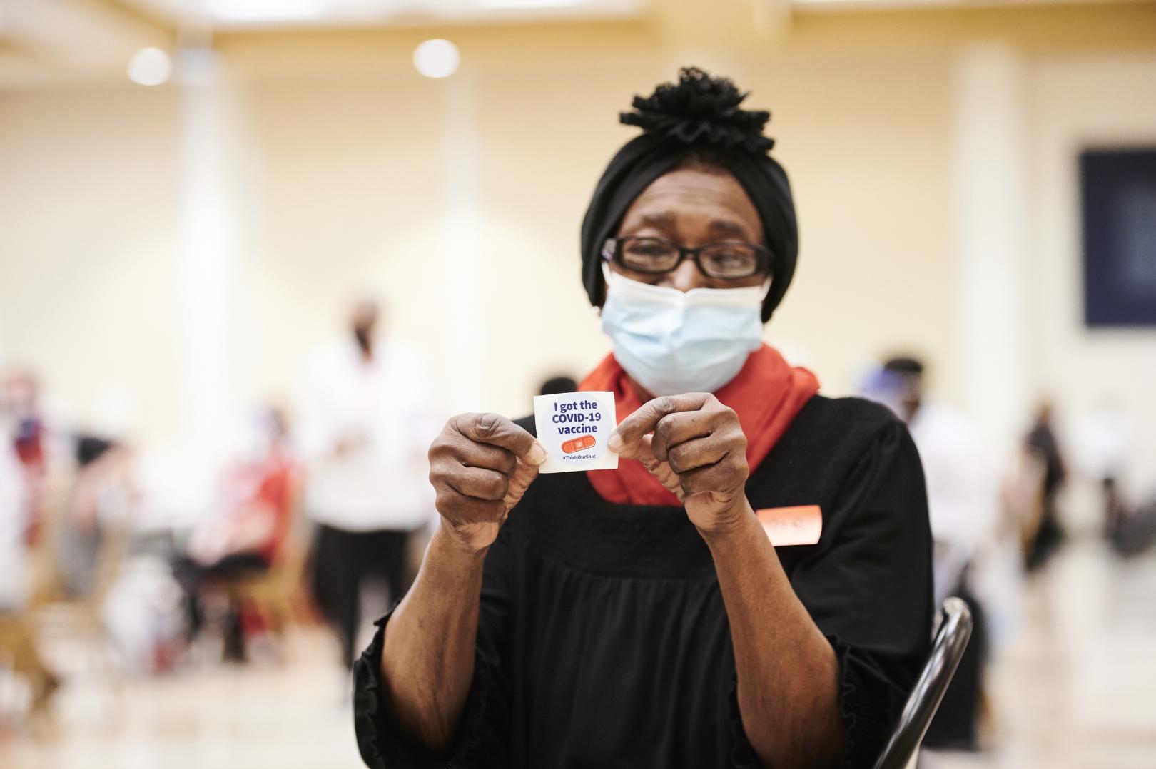 Female patient with vaccine sticker | Walgreens Boots Alliance